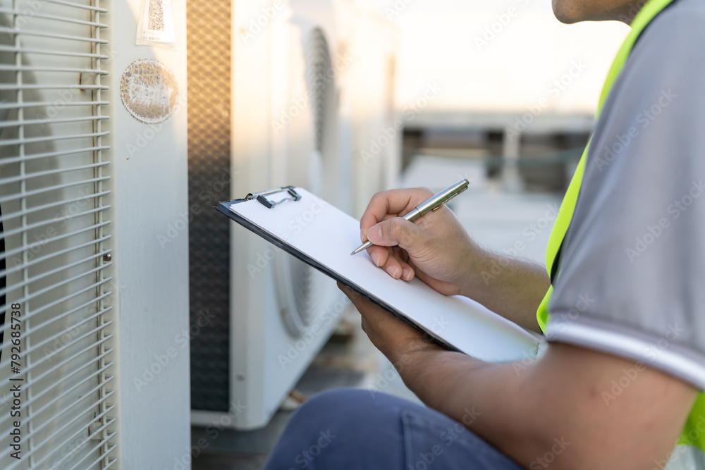 maintenance engineer works on the roof of factory. contractor inspect ...