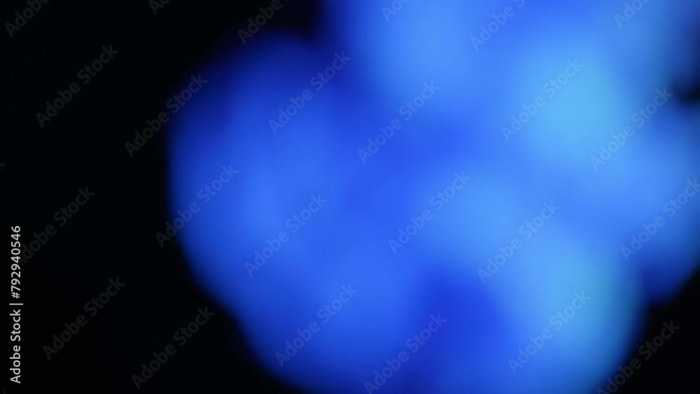 Blurred and abstract background of blue steam or gas cloud flow ...
