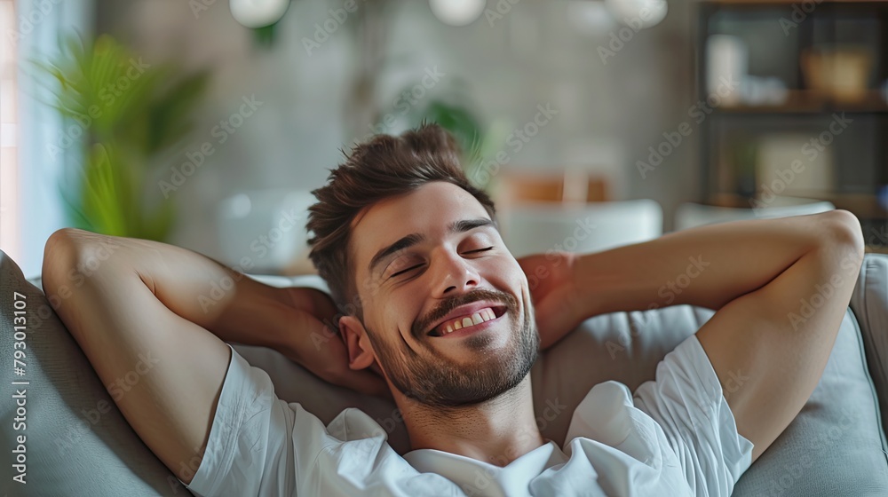 Handsome man relaxing on the sofa at home in the living room, resting ...