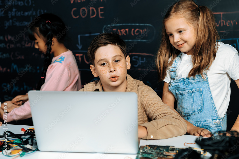 In classroom student in STEM class learning about coding robotics car ...