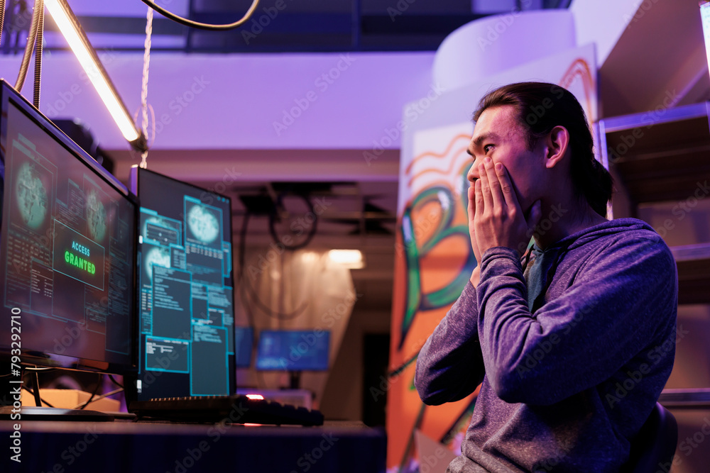 Excited hacker getting access granted while breaking into database server. Happy shocked young ...