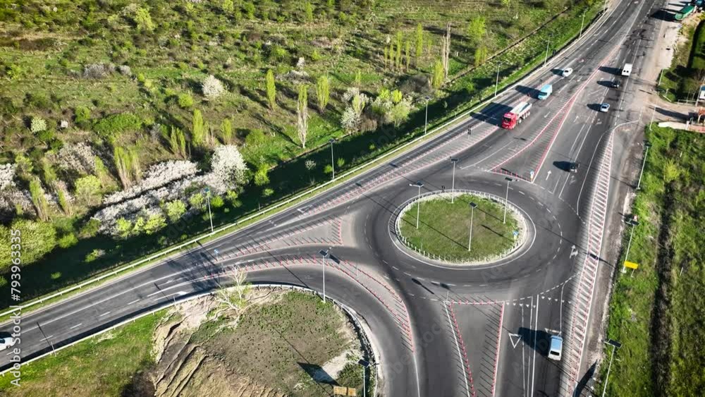 Vehicles on a roundabout junction. Roundabout with barriers and driver ...