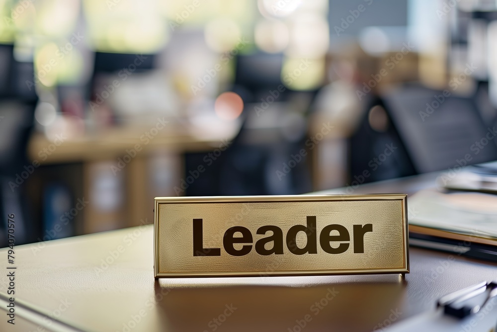 office desk placard that says "Leader" on it with a soft focus ...