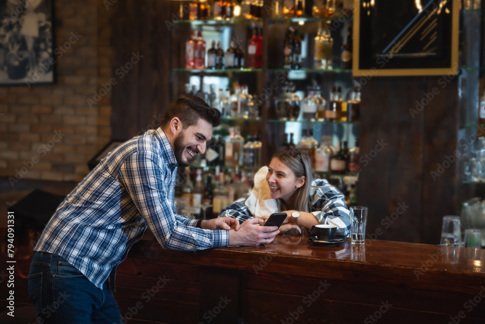 Two barista bartender or waiter workers woman and man working in bar ...