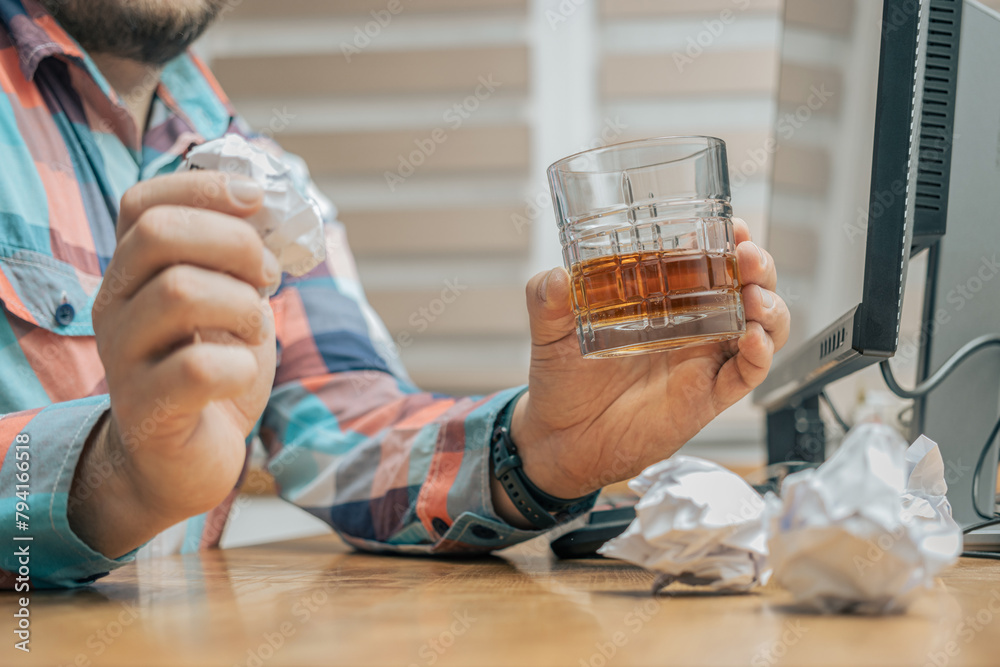 Drunk and frustrated man in the office while working with pc, sitting ...