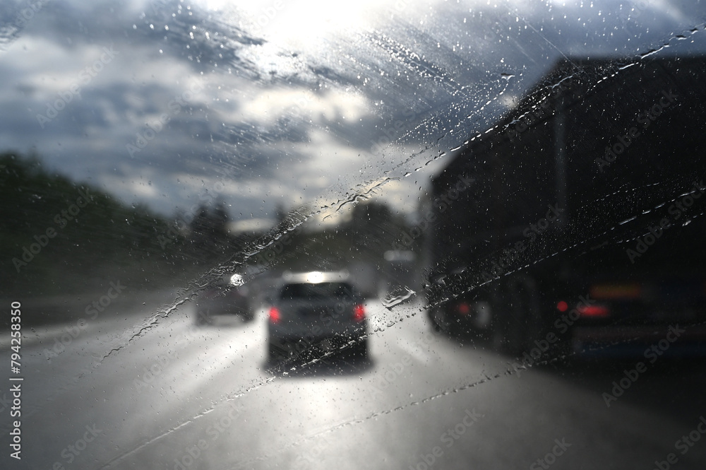 Poor visibility view with the car on the highway with spray and splash ...