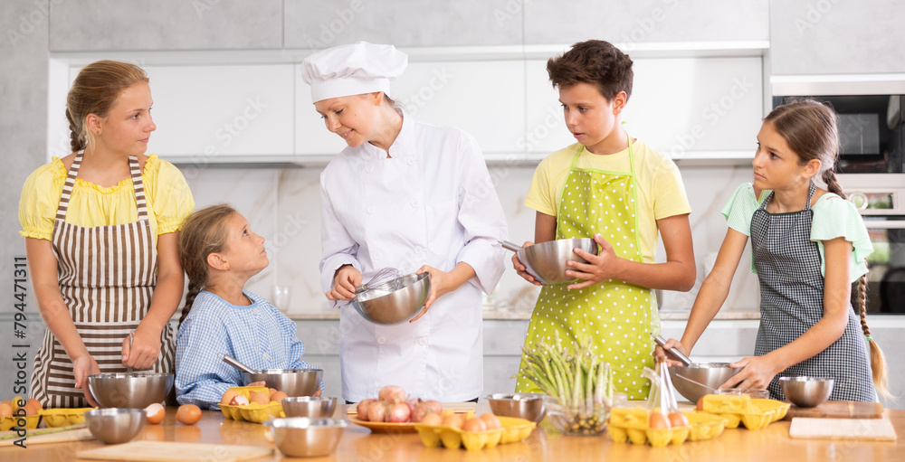 Amiable woman, qualified chef wearing white cook jacket and toque ...