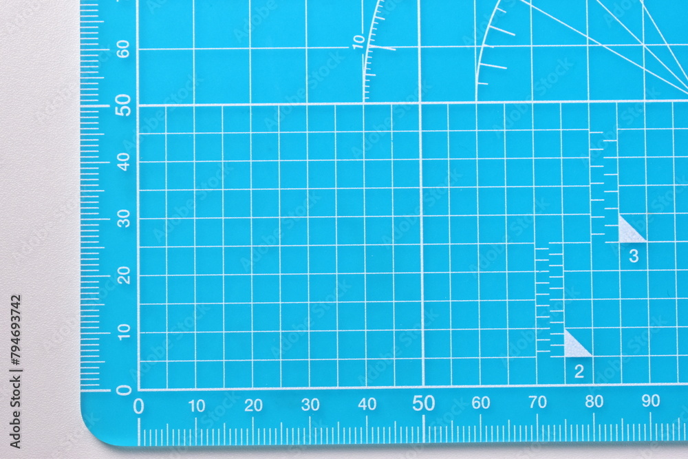 blue cutting mat board on white background with line and scale measure ...