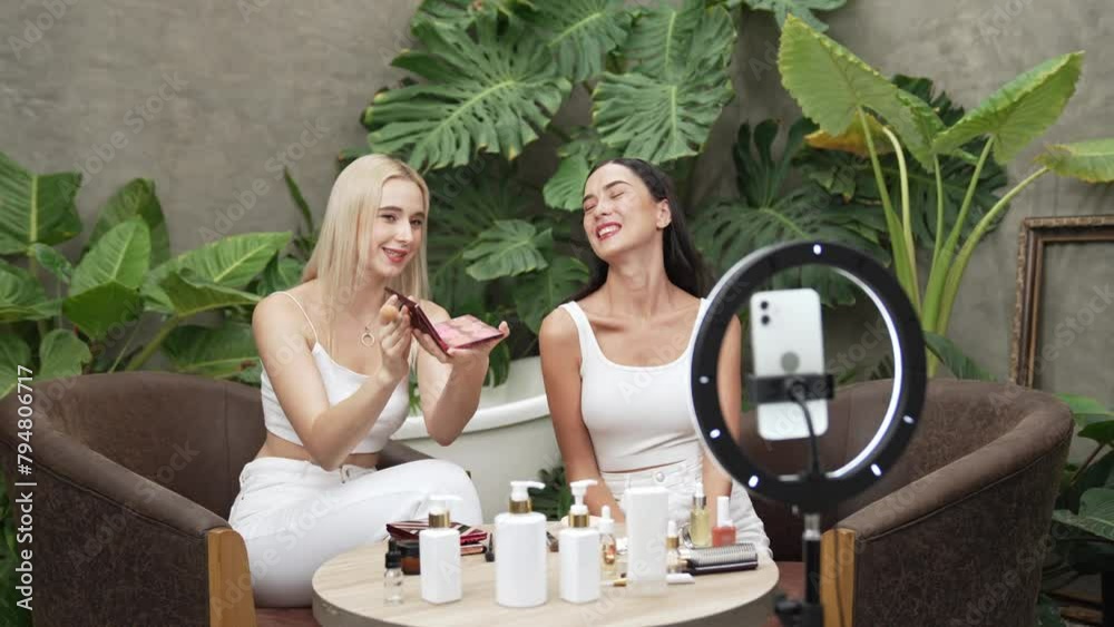 Two beautiful content creator making natural beauty and cosmetic tutorial on green plant leave ...