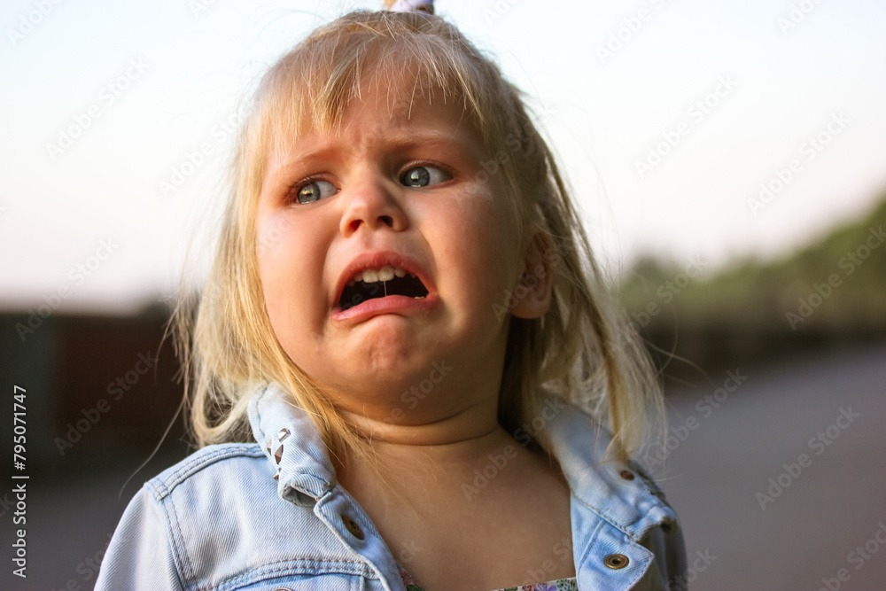 Unhappy child crying loudly with mouth open because of parents' divorce ...
