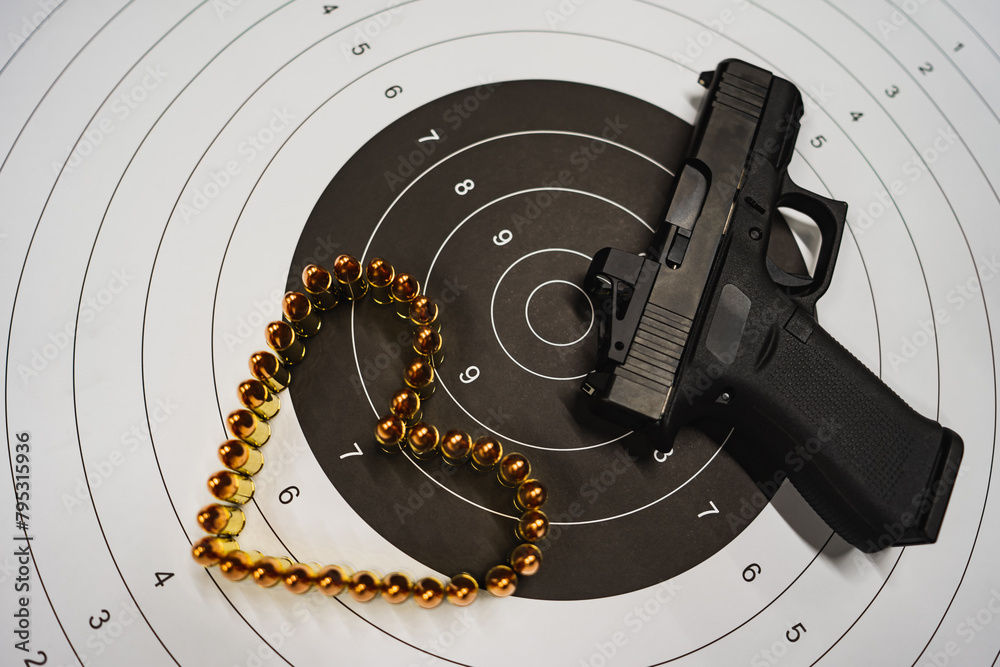 Firearm, modern 9mm compact pistol with red dot, paper target and heart ...