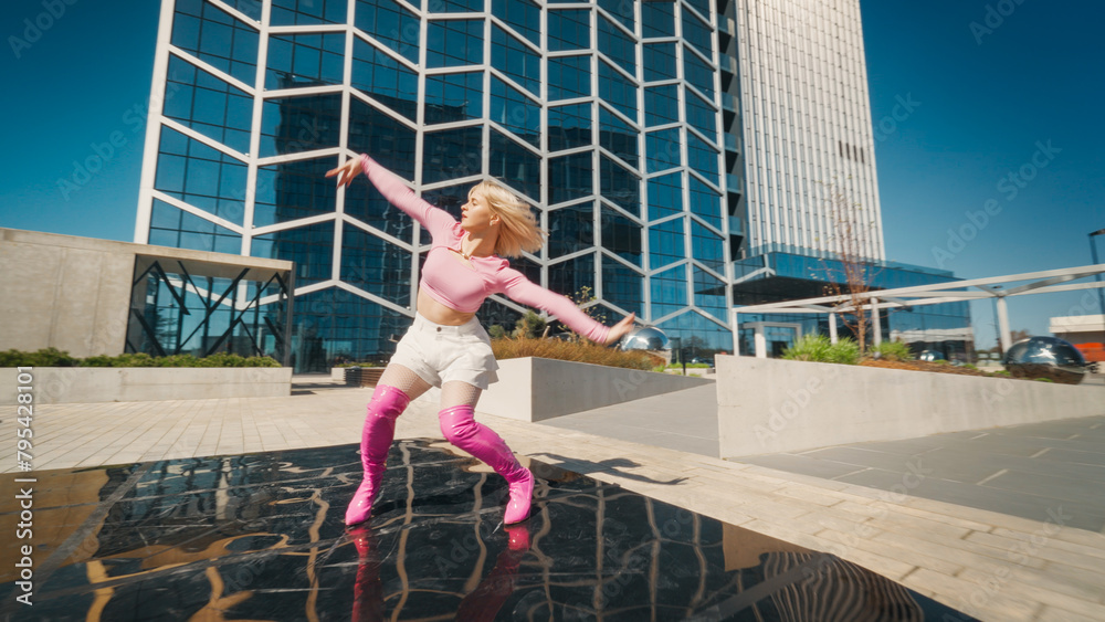 A Vibrant Young Woman Dances Energetically In A Modern Urban Setting ...