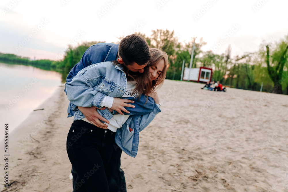 beautiful and young lovers, guy and girl kissing and hugging. Happy ...