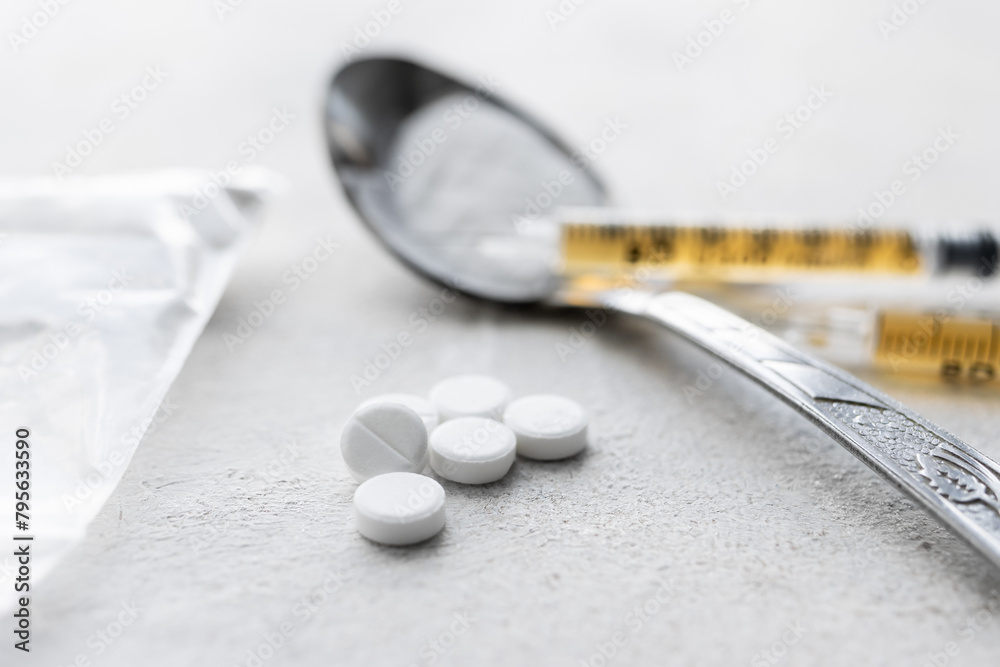 Narcotic substances in a spoon, dope powder in transparent plastic bag ...