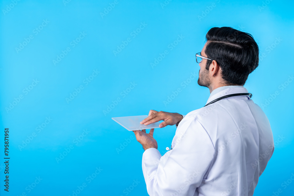Back view of skilled doctor looking and pointing while holding ...
