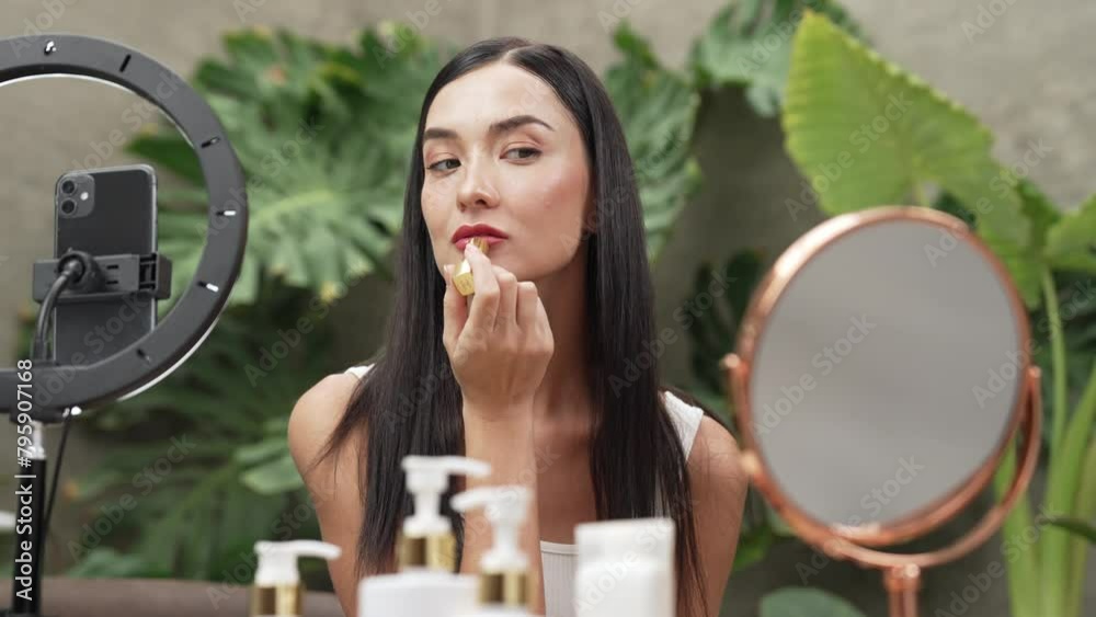 Beautiful content creator making natural beauty and cosmetic tutorial at green plant leave ...