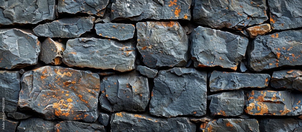 Detailed close-up of an old stone wall covered in rust and weathering ...