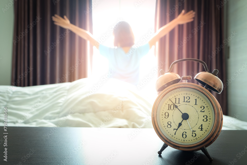 Morning of a new day, alarm clock wake up man sitting in the room. A ...