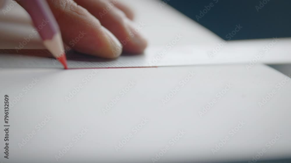 Person using a ruler to draw a straight line on a piece of paper Stock ...