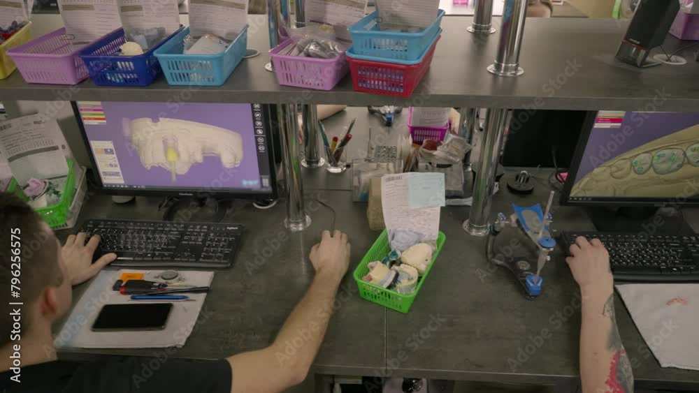Dental specialists using the 3D software to create artificial teeth ...