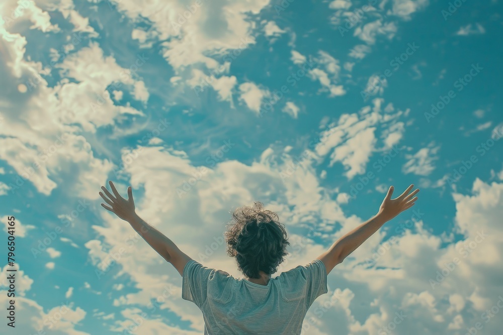 Back view of a man lift his hands to the sky and feel freedom outdoor ...