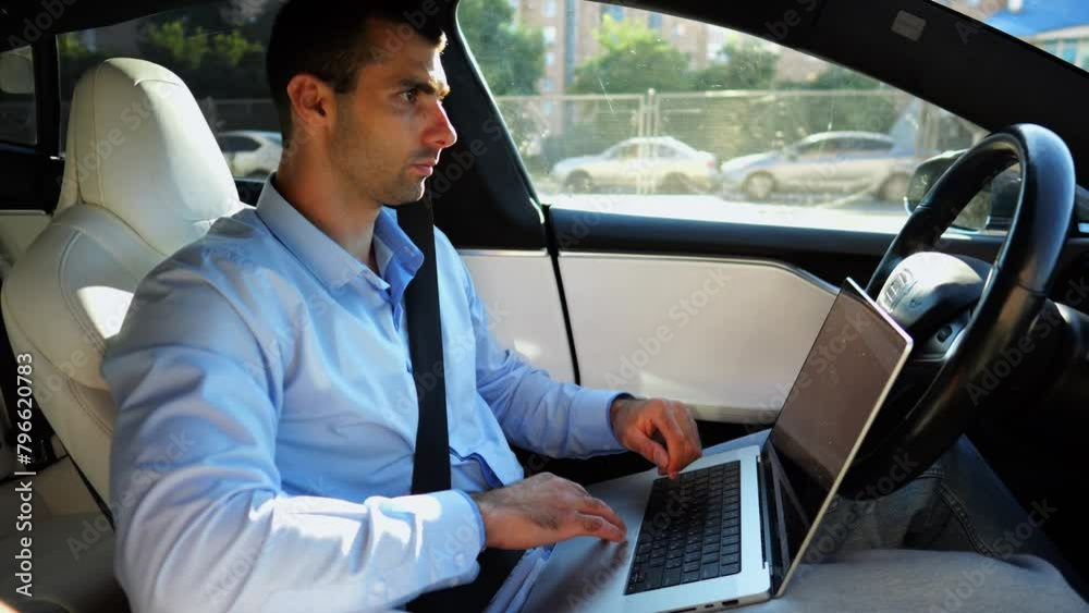 Vidéo Stock Handsome entrepreneur working on notebook while riding an ...