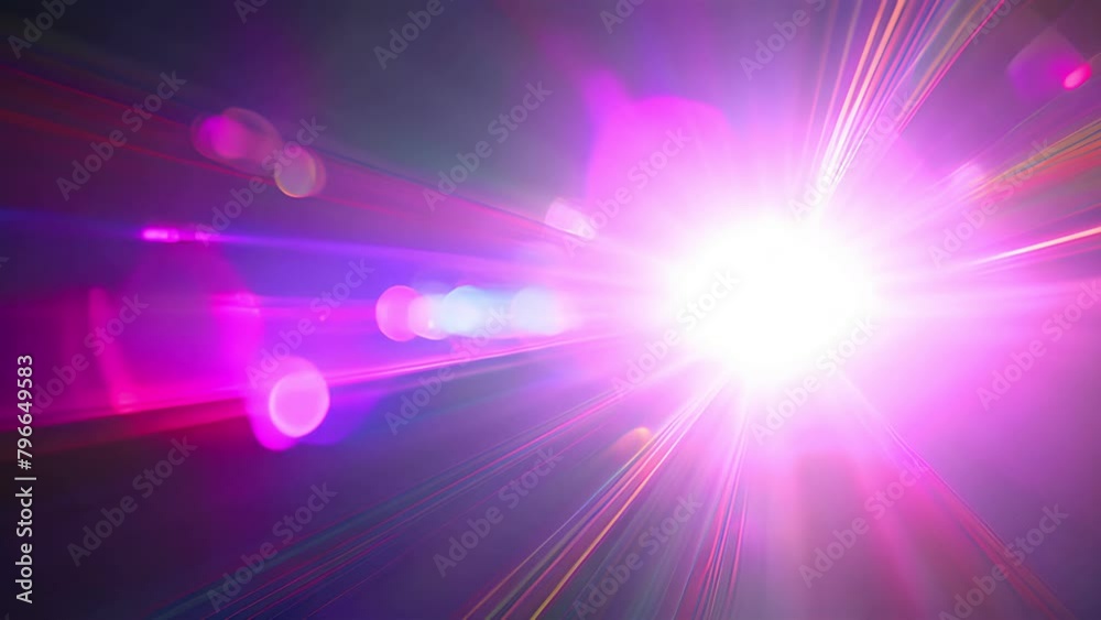 colorful light shining through a dark background. The light is bright ...