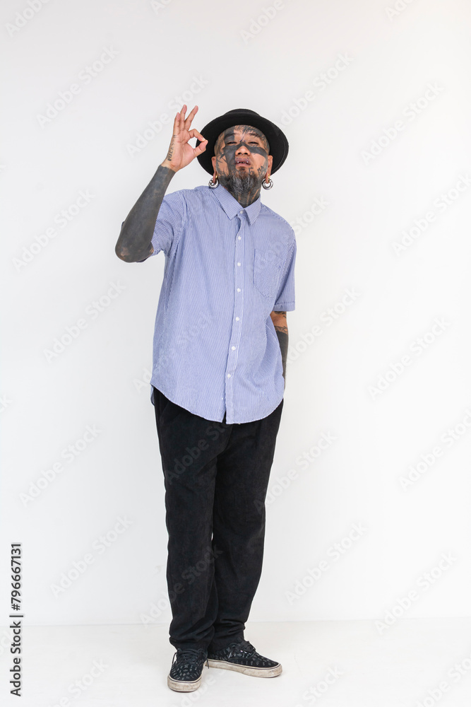 Whole body photo - A stylish Asian man with extensive face tattoos and ...