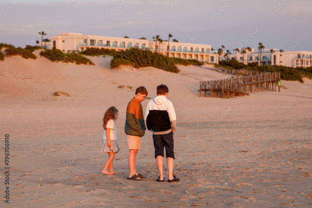 Portrait of three children, happy kids on beach at sunset. happy family ...