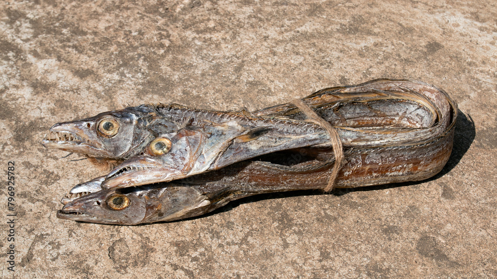 asian ribbon fish or hairtail on rugh background. Dried sea fish from ...