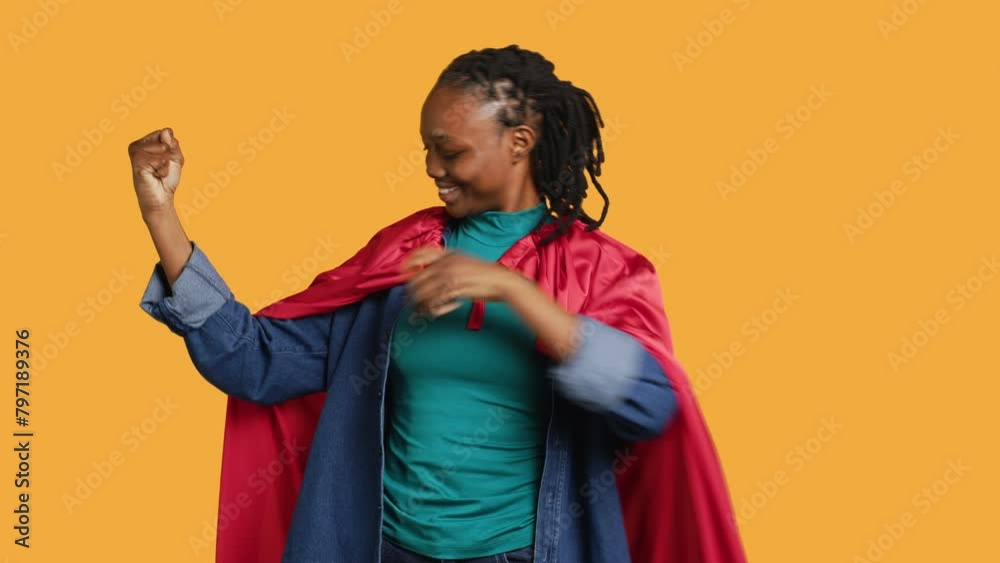 Happy superhero flexing muscles to prove force, listening music ...