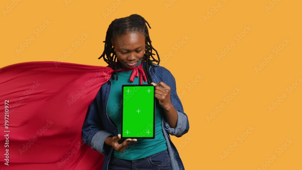 Portrait of joyful woman portraying superhero showcasing green screen ...