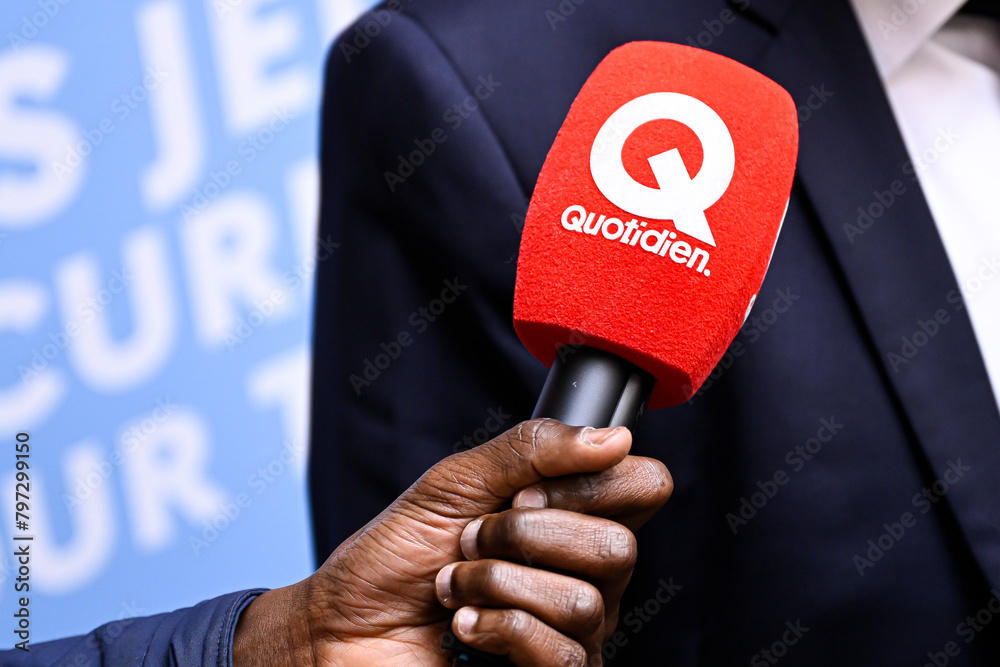 Illustration picture shows a journalist holding a microphone (mic, mike ...