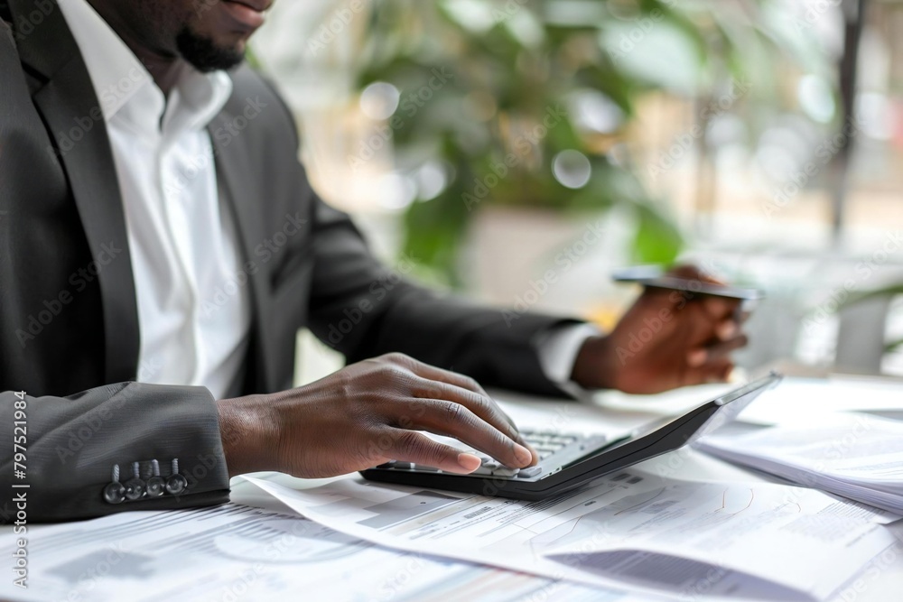 Man in office calculating budget numbers on invoices Stock Photo ...
