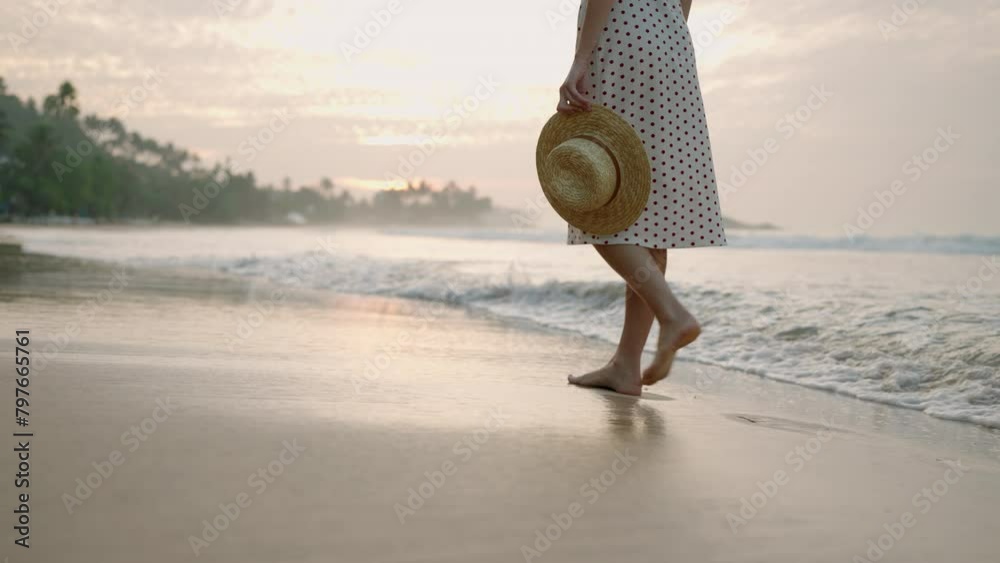 Female feet going barefoot in sea surf water edge at sunset. Splashing ...