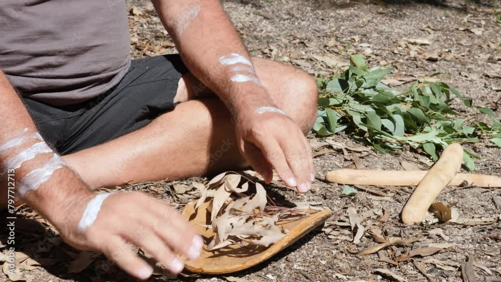 Australian Aboriginal Smoking Ceremony, man with a traditional wooden ...