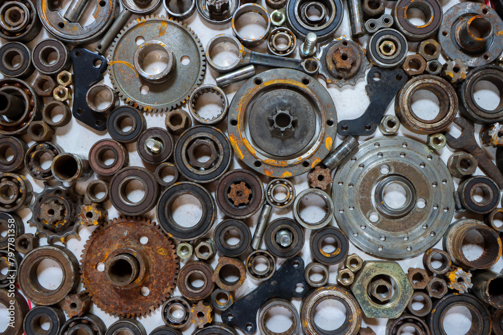 The old rusty car bearing texture background and old motorcycle parts ...