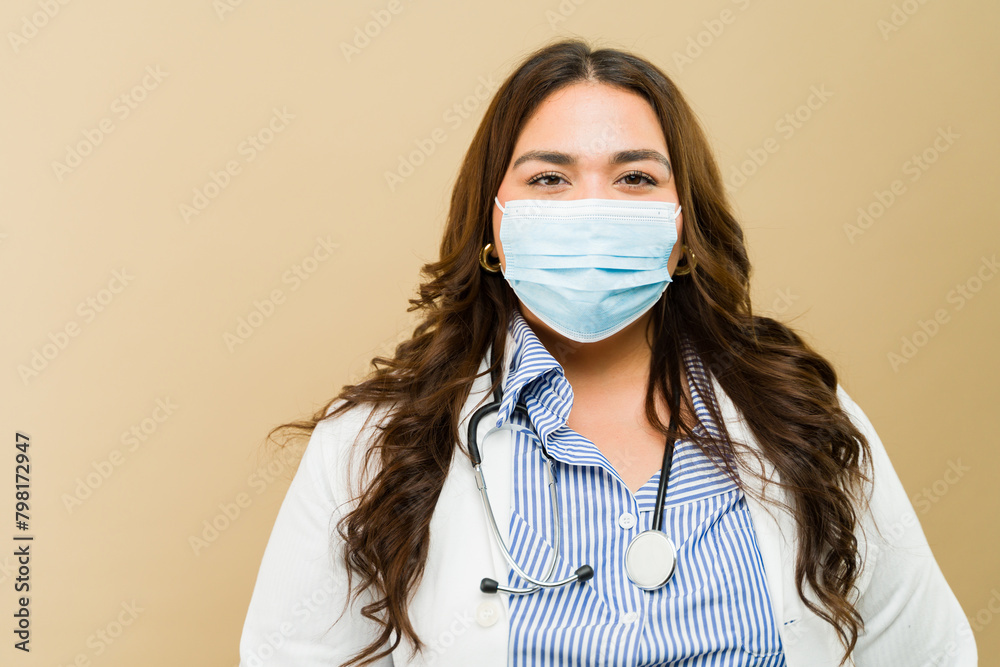 Plus-size woman in medical attire and mask, posing in a studio Stock ...
