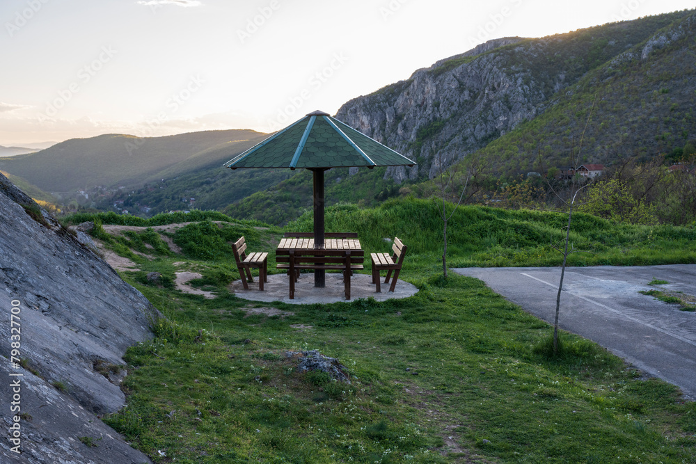 Table in the mountain resting place with a canopy from the rain and ...