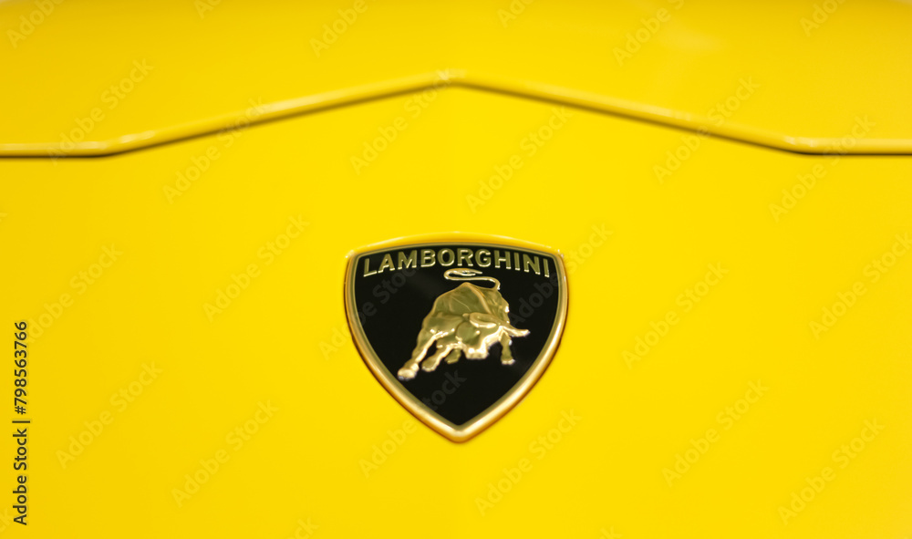 Logo of the car in yellow Lamborghini Urus. Lamborghini logo on a ...