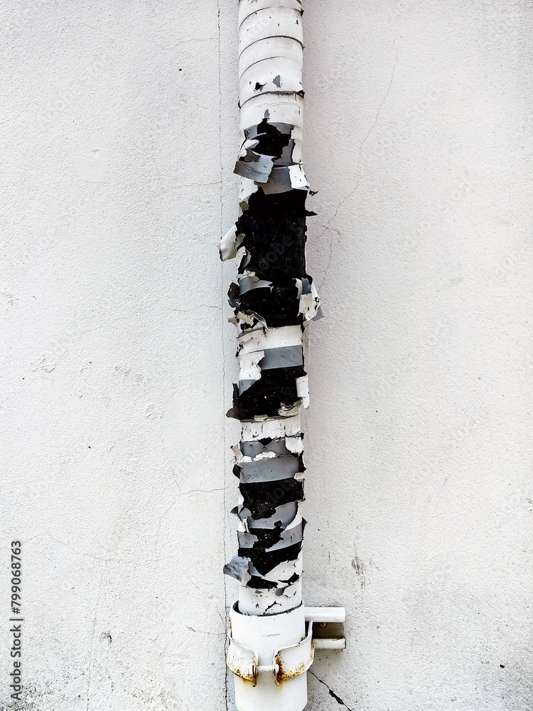 Old air conditioner drain hose with broken insulation. Air conditioning ...