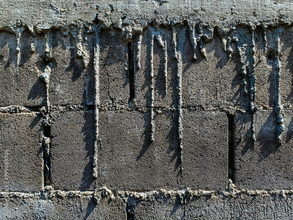 Dry cement drips on bricks wall. Mortar dripping and running down the ...