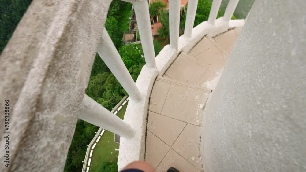 POV walking down spiral staircase of Ambuluwawa Tower, rich plants ...