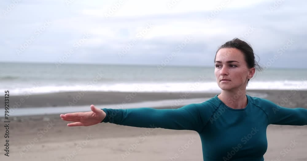Portrait of a young woman doing breathing practices and yoga on a black ...