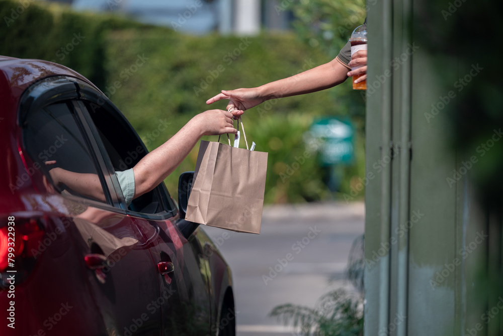 Hand Man in car receiving coffee in drive thru fast food restaurant ...