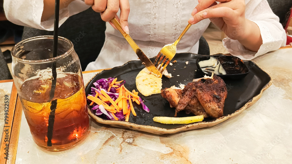 portrait of woman's hands slicing khubus (pita bread) accompanied by ...