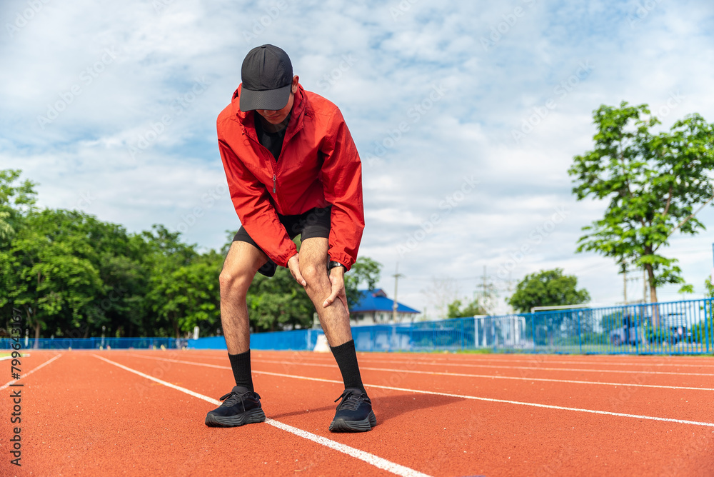 Young asian runner athlete with muscle pain. Man massaging Stretching ...