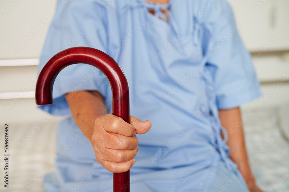 Asian elderly disability woman patient holding walking stick in ...