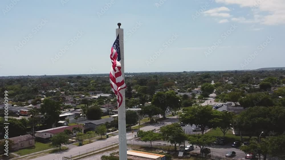 US flag waving gracefully, while the camera pans to the left, revealing ...