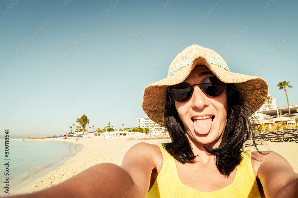Happy young silly tourist taking selfie show tongue pose at beach on ...